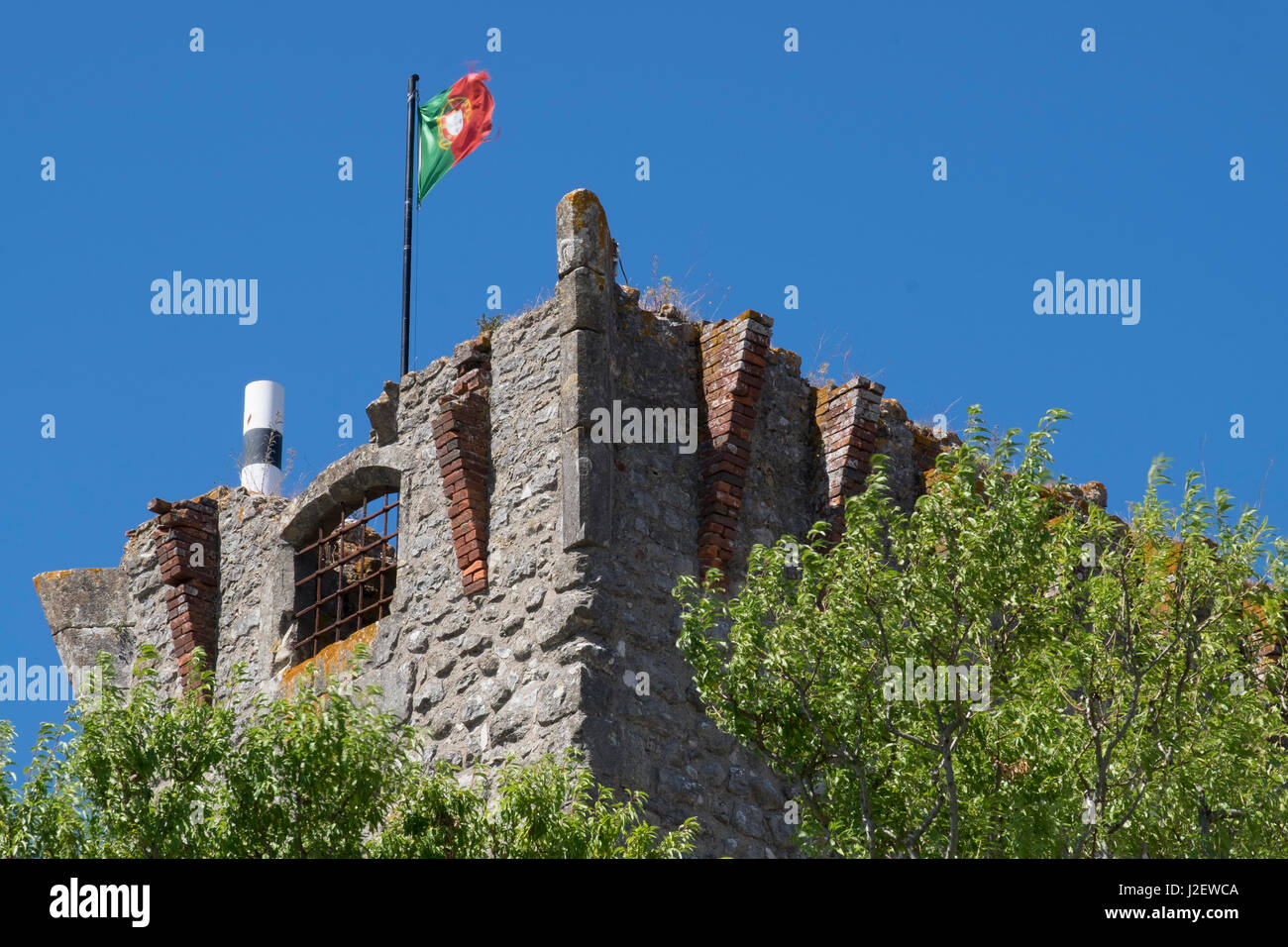 Portugal, Ourem, Ourem castle tower with Portuguese flag. Old section ...