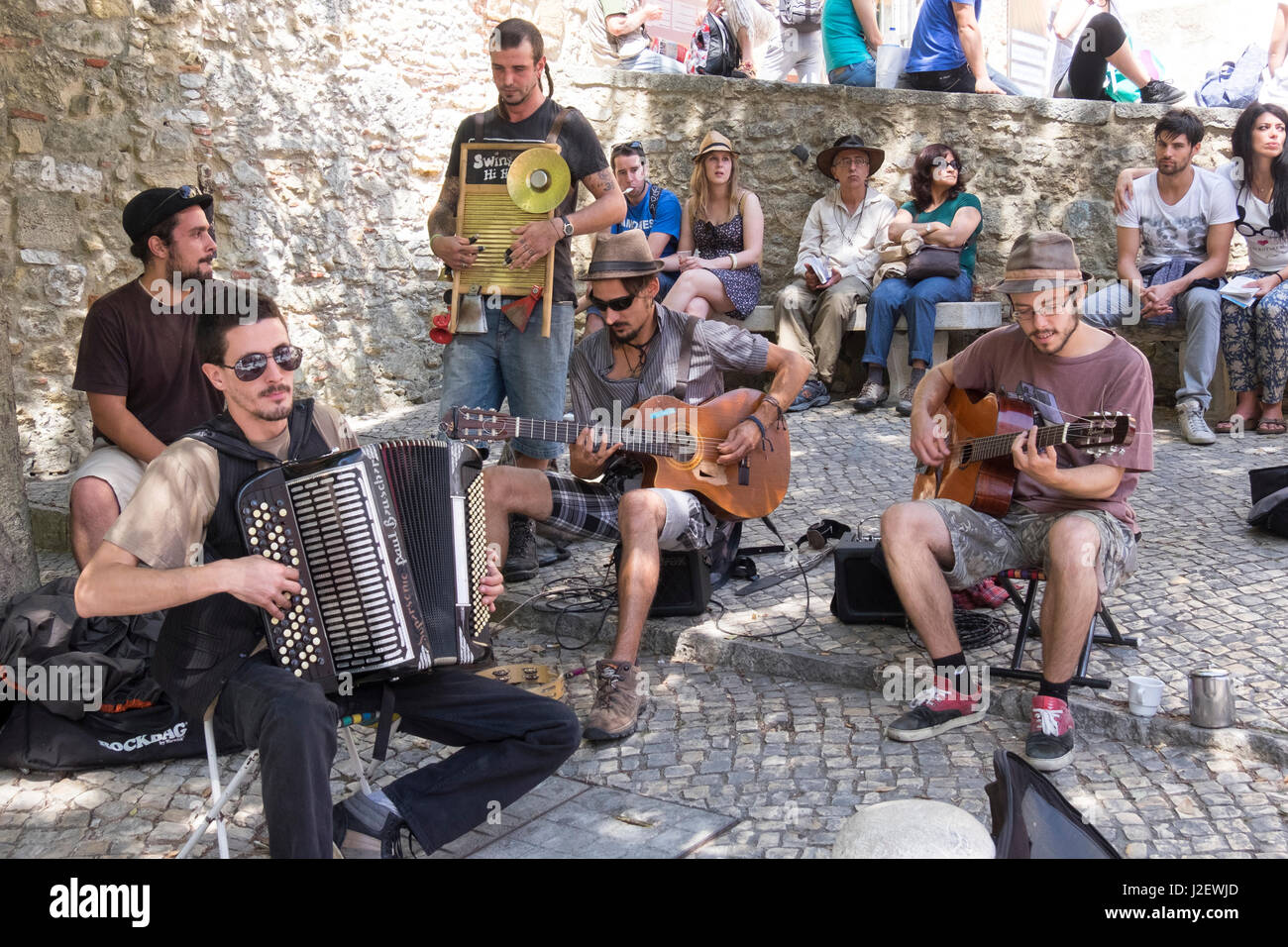 Portugal, Lisbon. Street musicians play local music near the entrance ...