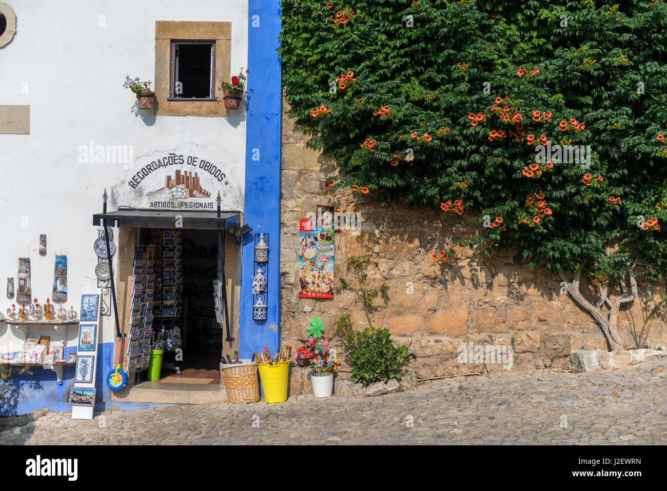 Portugal, Obidos, souvenir store and orange trumpet creeper (Large ...