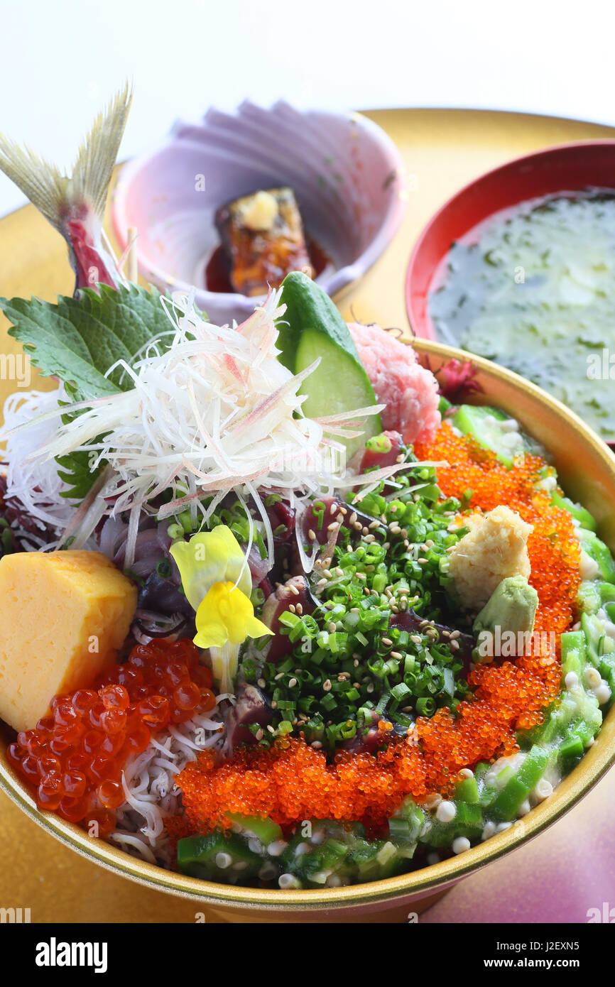 Bowl of sushi sashimi with red eggs, wasabi, fish and seaweed soup ...