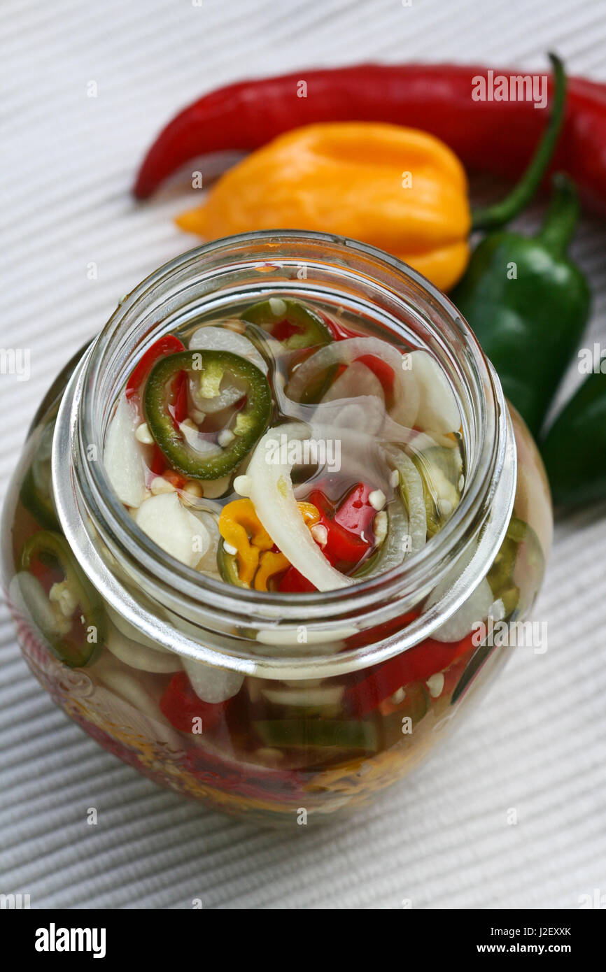 Fermented garlic and chili in glass bottle Stock Photo - Alamy