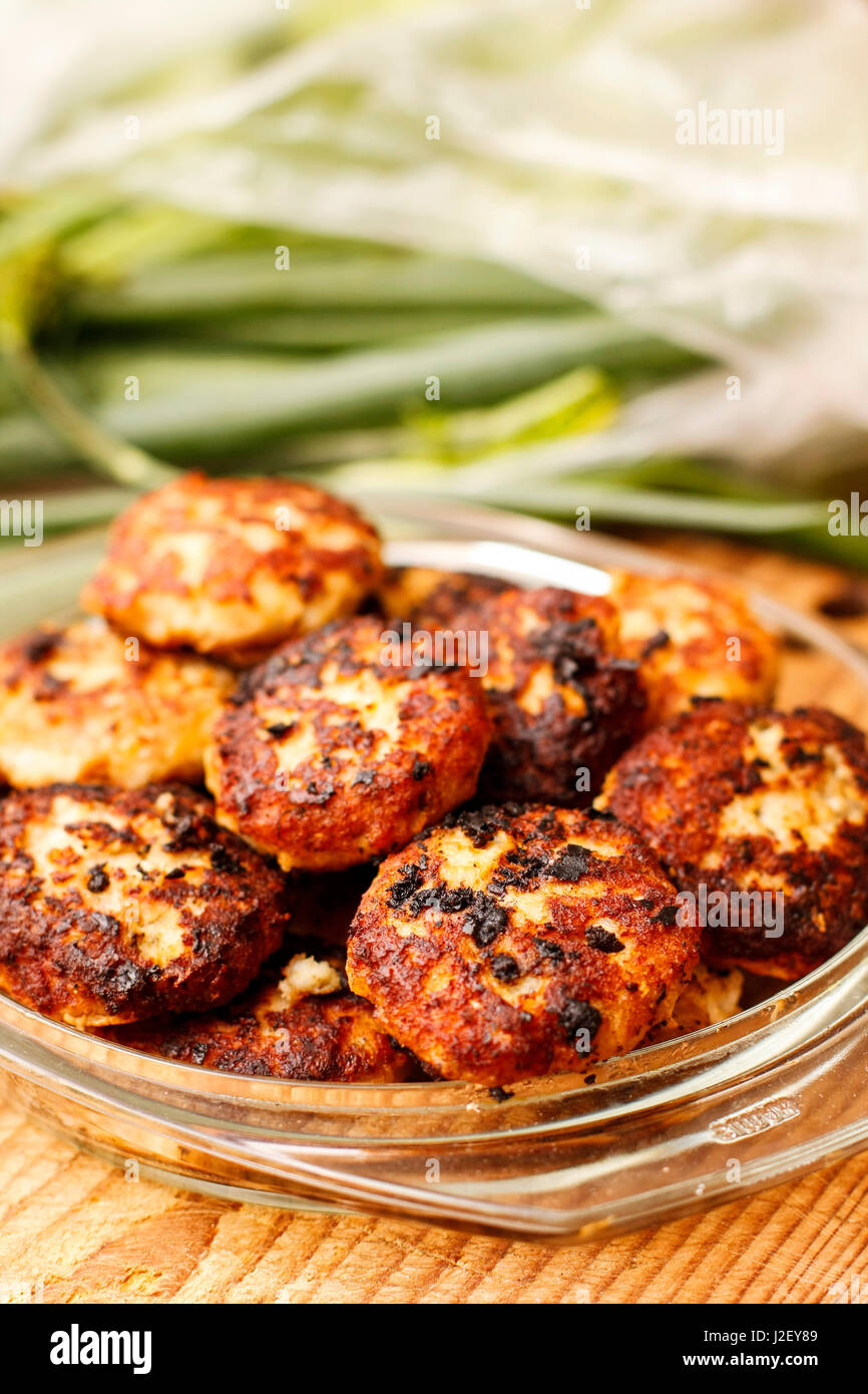 Pike cutlets fried with onion in glass platter Stock Photo - Alamy