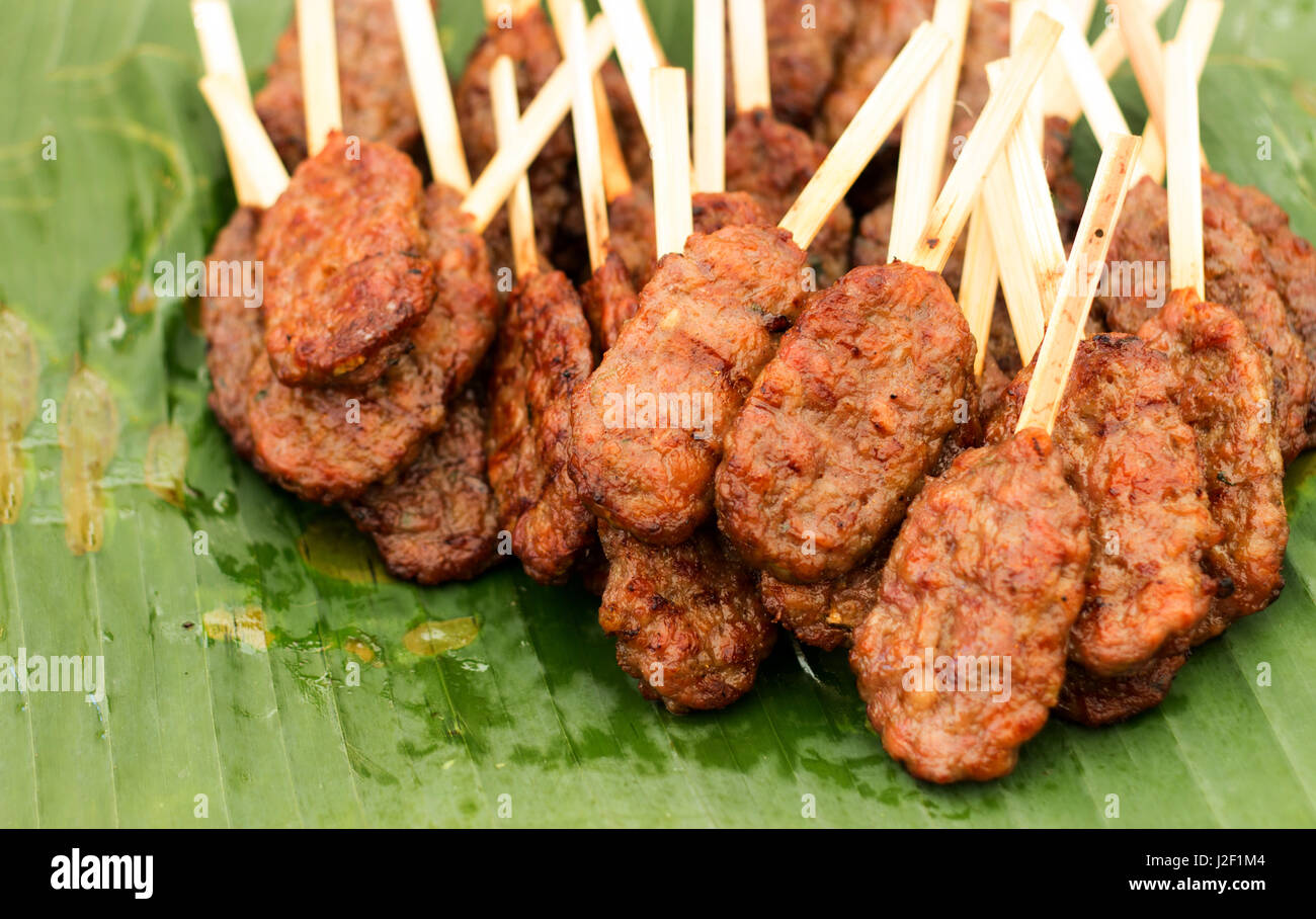 close up pork grill with wood stick famous fast finger food in thailand ...