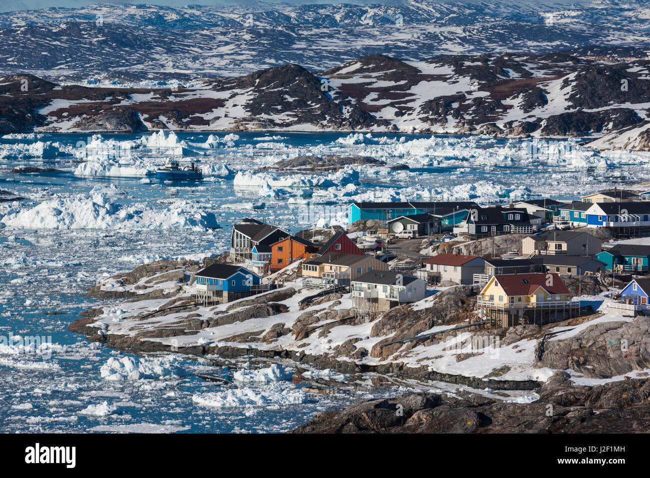 Greenland, Disko Bay, Ilulissat, elevated town view with floating ice ...