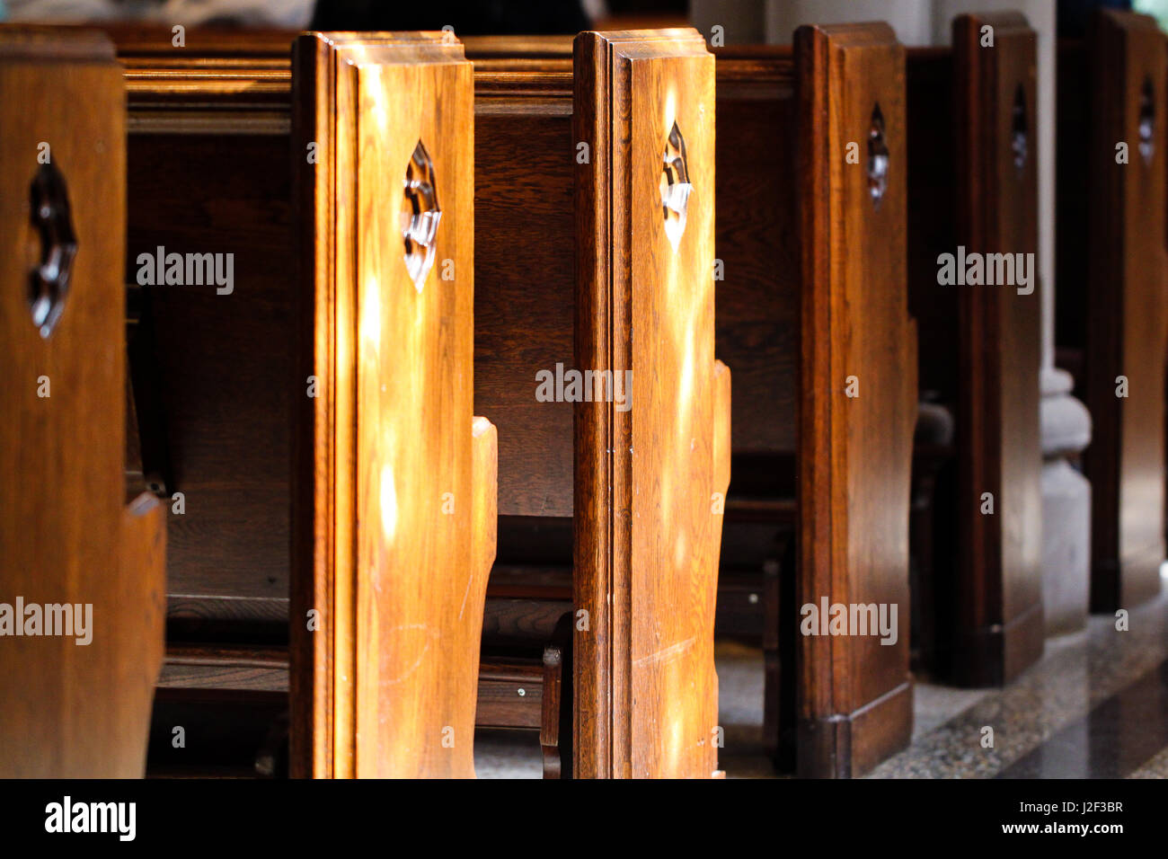 Church interior. Row of church pews lit by early morning sun Stock ...