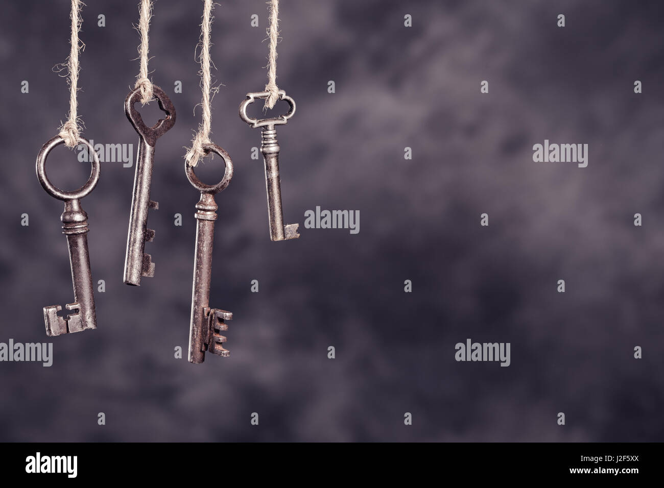 Four old keys hanging Stock Photo - Alamy