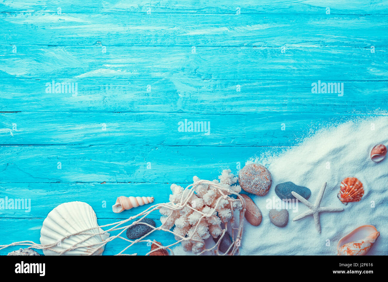 Sea sand and shells on turquoise Stock Photo - Alamy