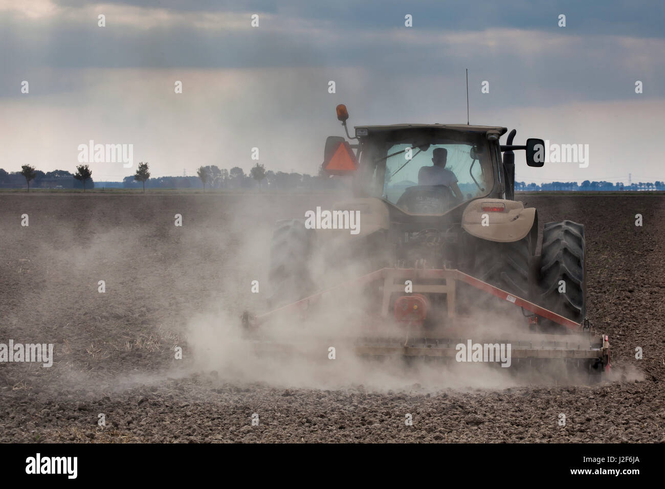 Tractor working dry clay Stock Photo - Alamy