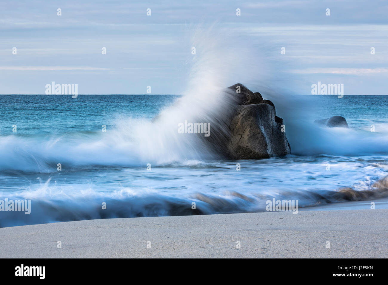 waves breaking on a rock Stock Photo - Alamy