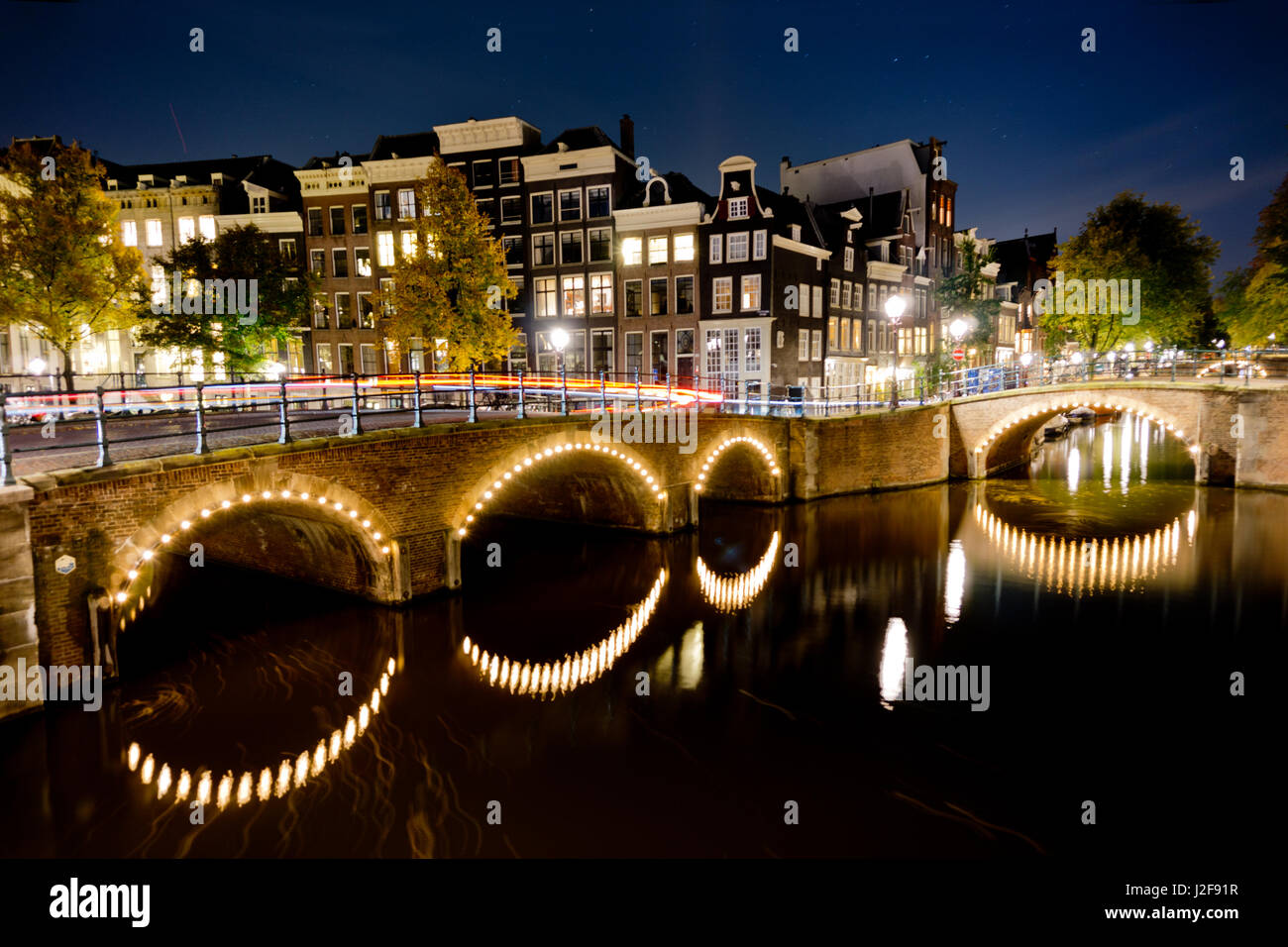 Amsterdam bridges at night Stock Photo - Alamy