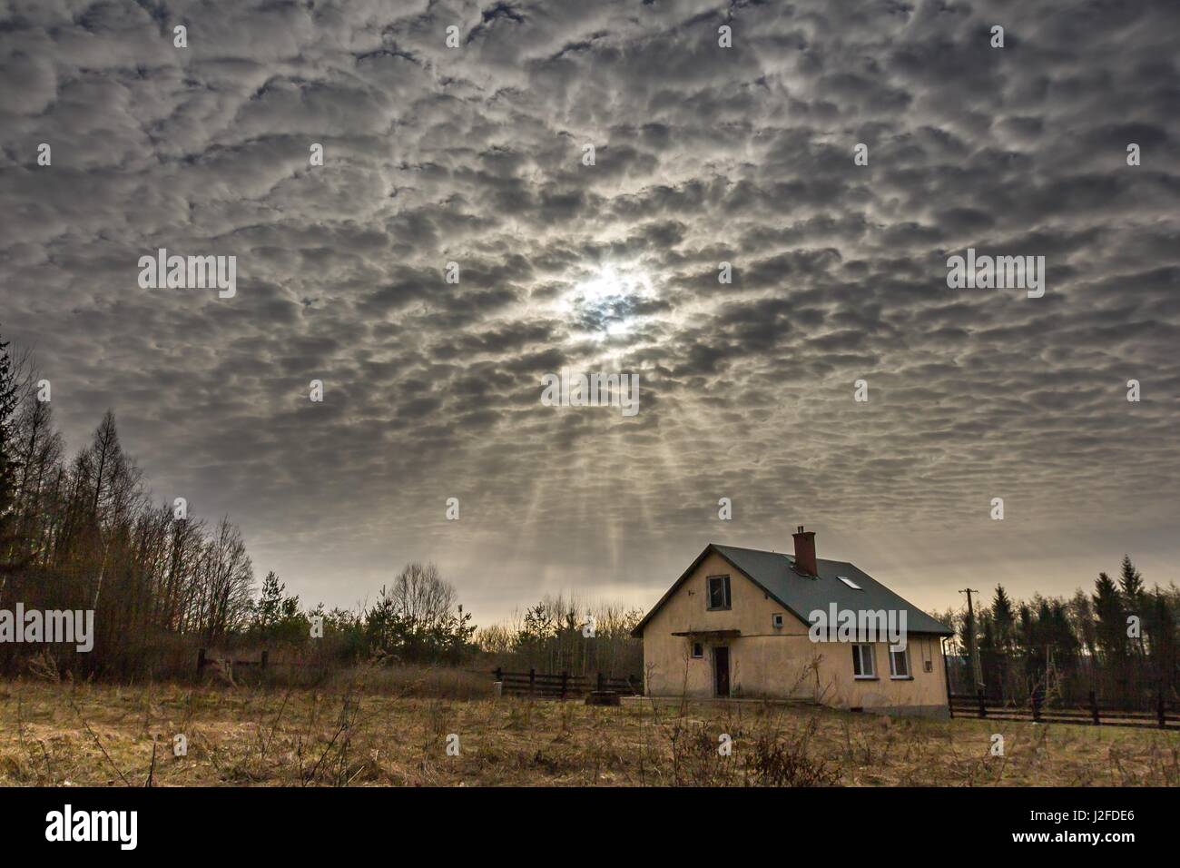 Landscape with house at day under cloudy sky. Spooky landscape with ...