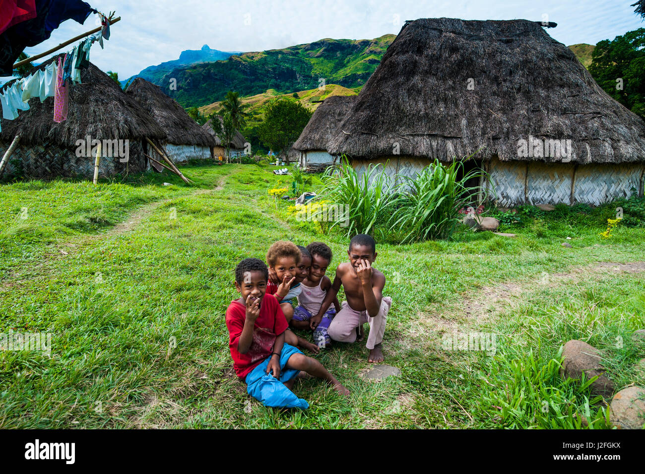 Local children before traditional thatched roofed huts in Navala in the ...