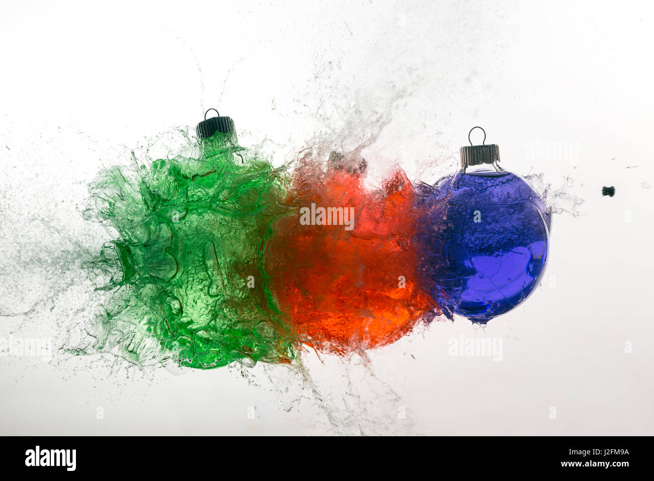 Stop action of Christmas ornaments filled with colored water and ...