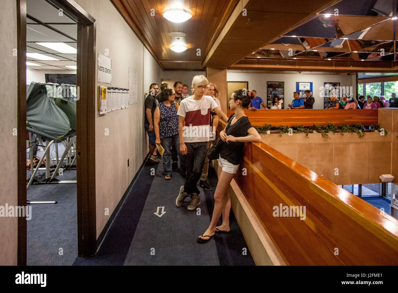 Multiracial voters of all ages patiently line up to cast their ballots ...
