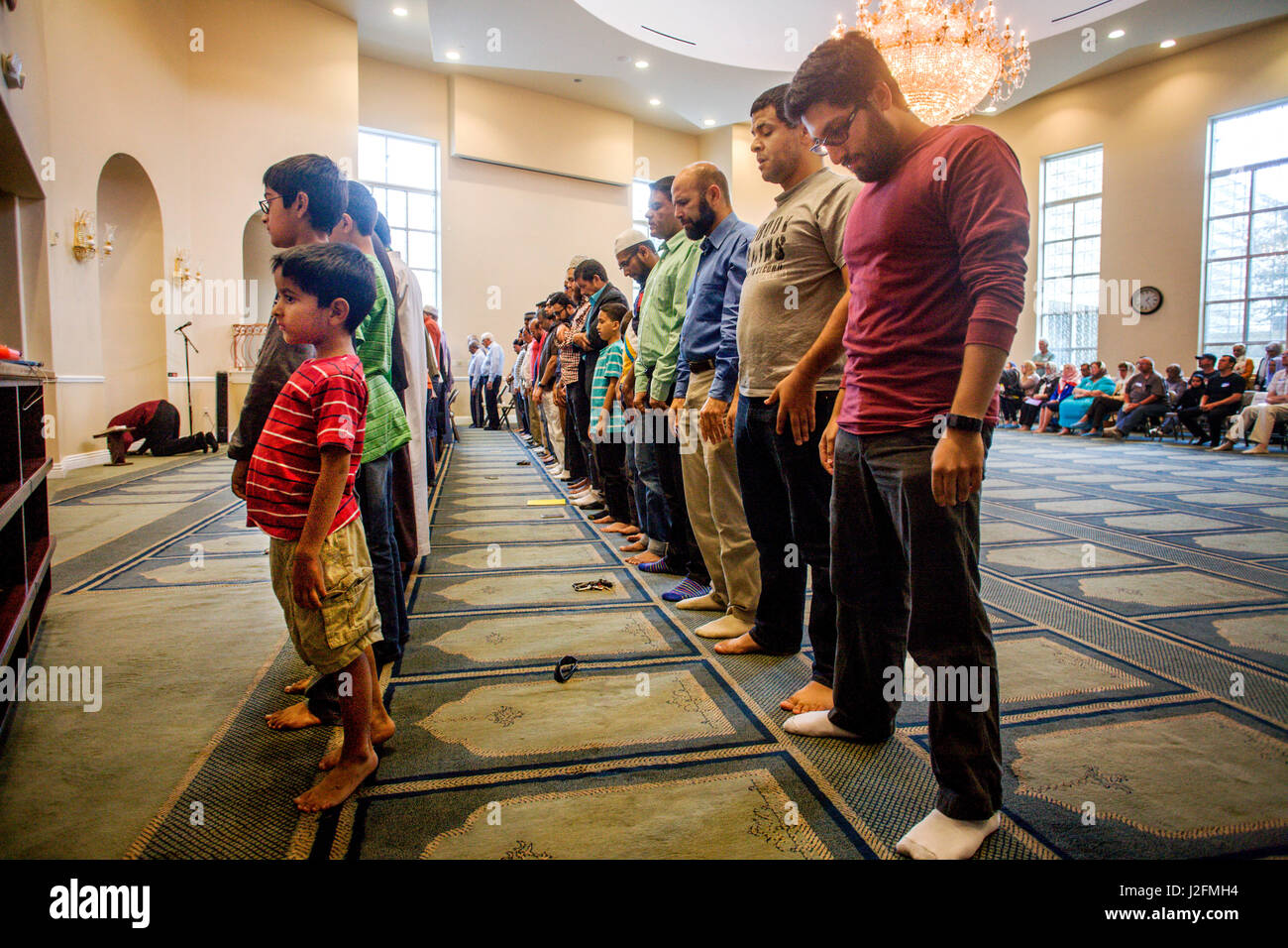 Muslim men bow in reverence during Friday afternoon prayers at ...