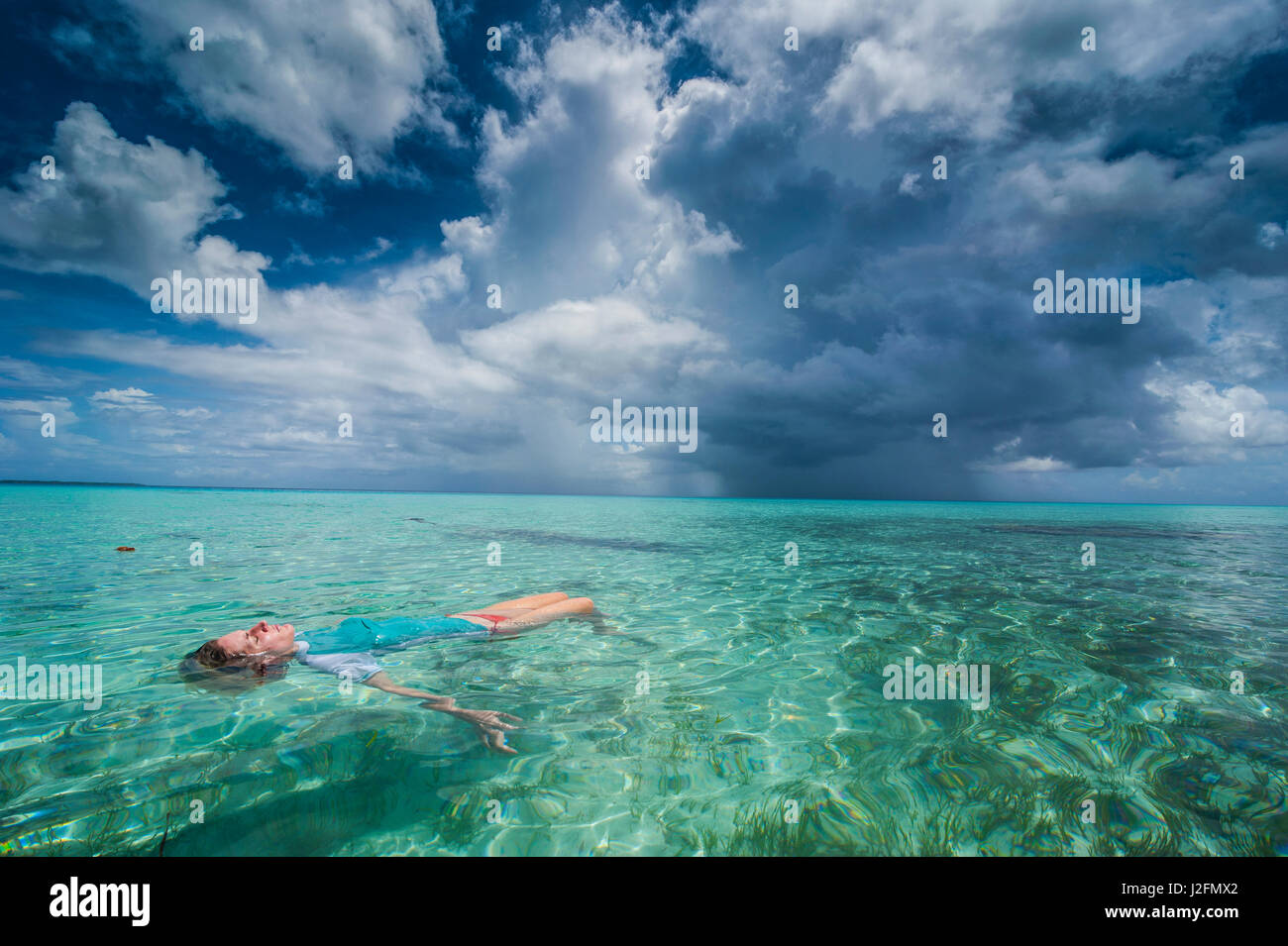 Tourist in the incredible blue waters of the Ant Atoll, Pohnpei ...