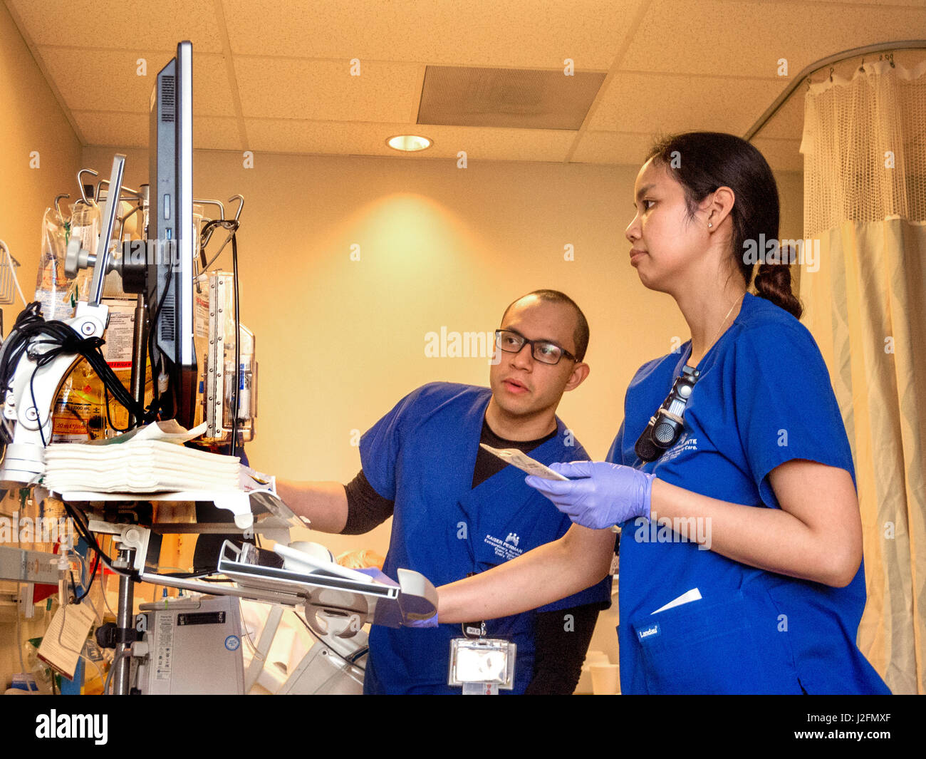 Two people looking at computer screens hi-res stock photography and ...