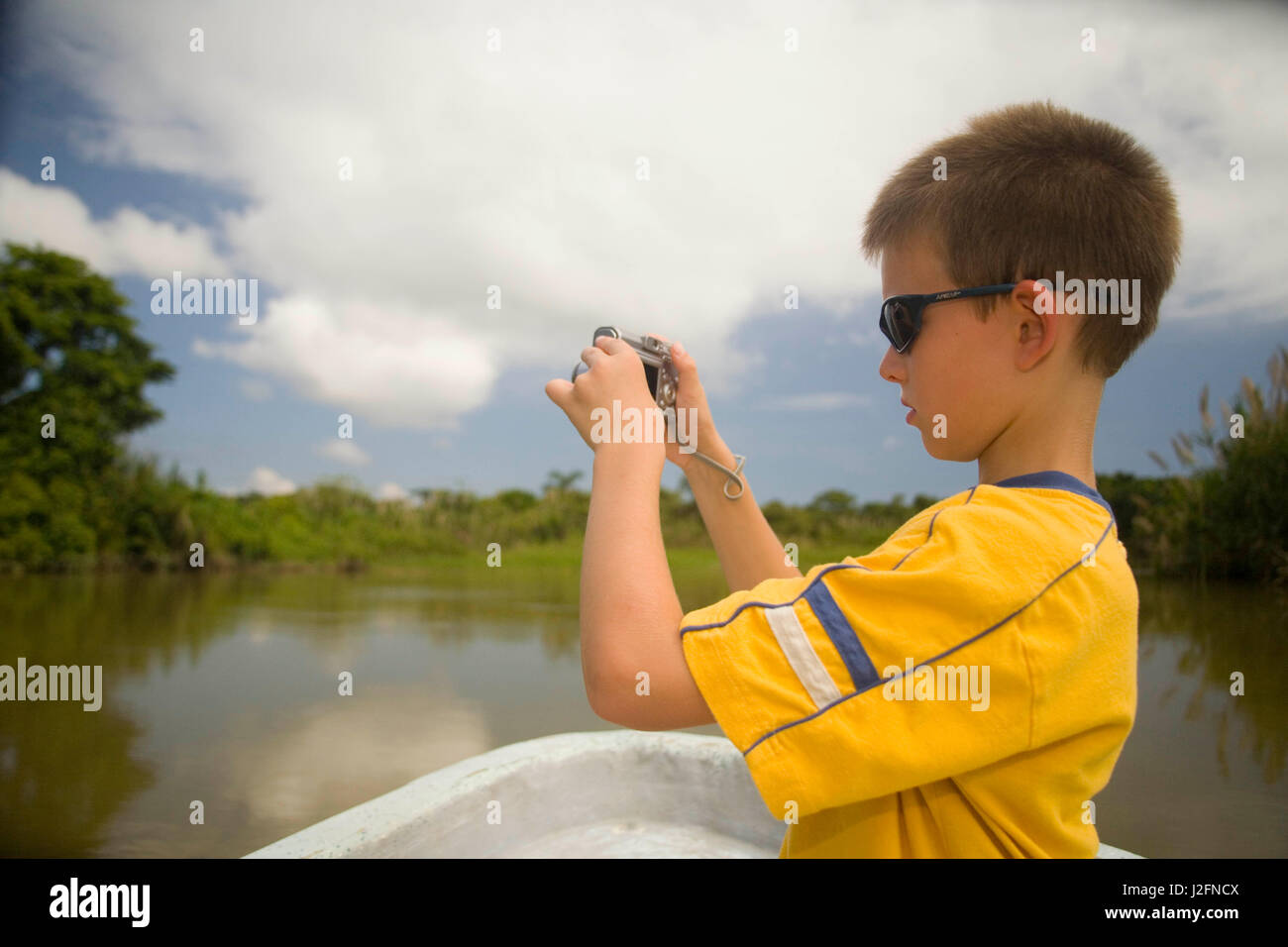 Central America, Belize, Placencia, Monkey river, boy (age 8) taking a ...