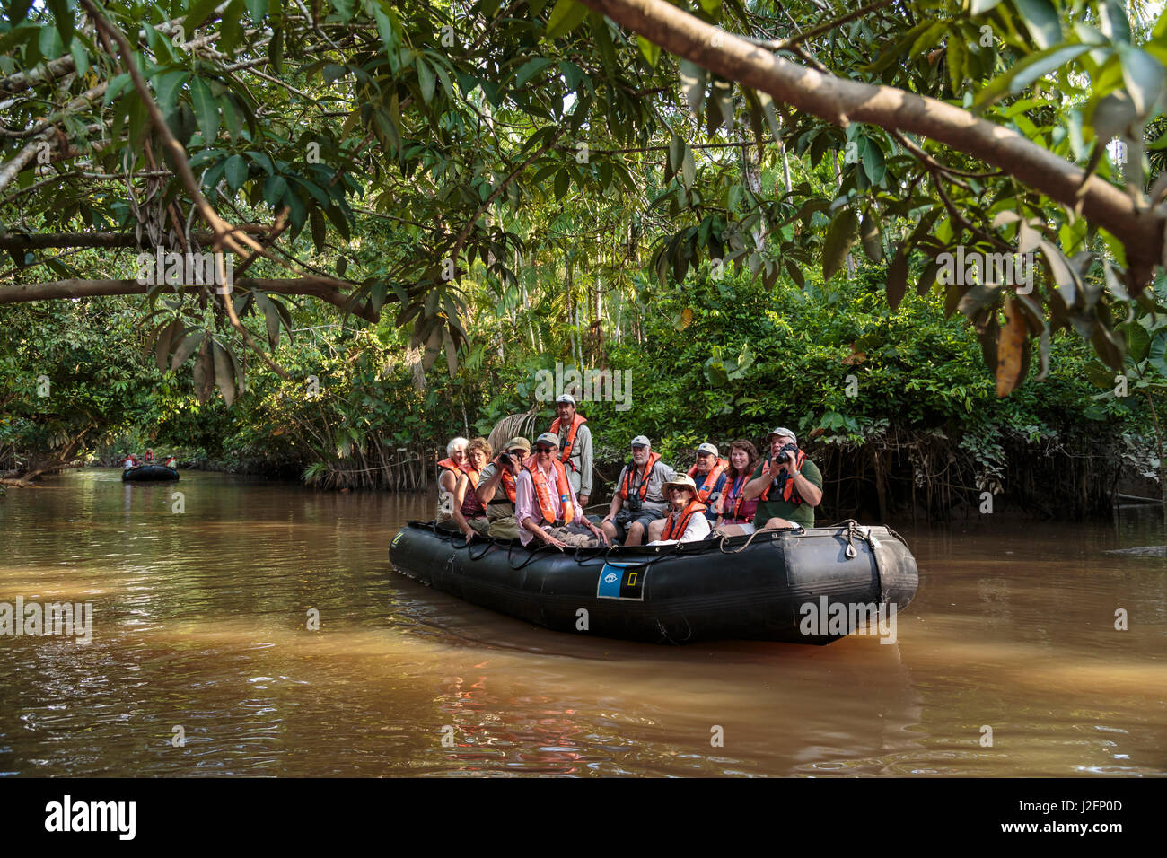 South America, Brazil, Amazon River. Tourists making their way down ...