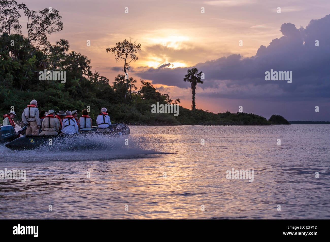 South America, Brazil, Amazon River. Tourists returning to ship on ...