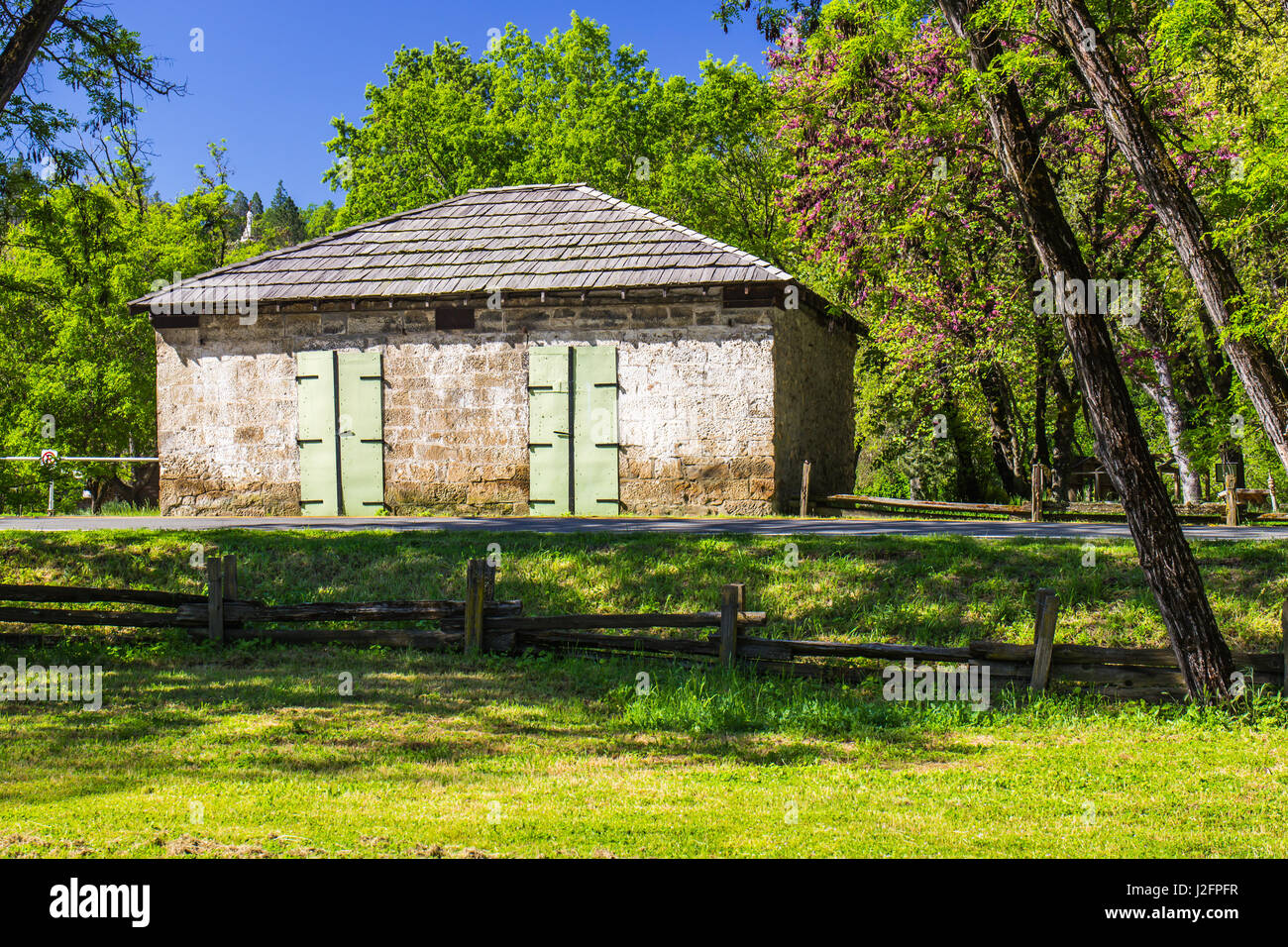 Old Block Building With Large Iron Doors Stock Photo - Alamy