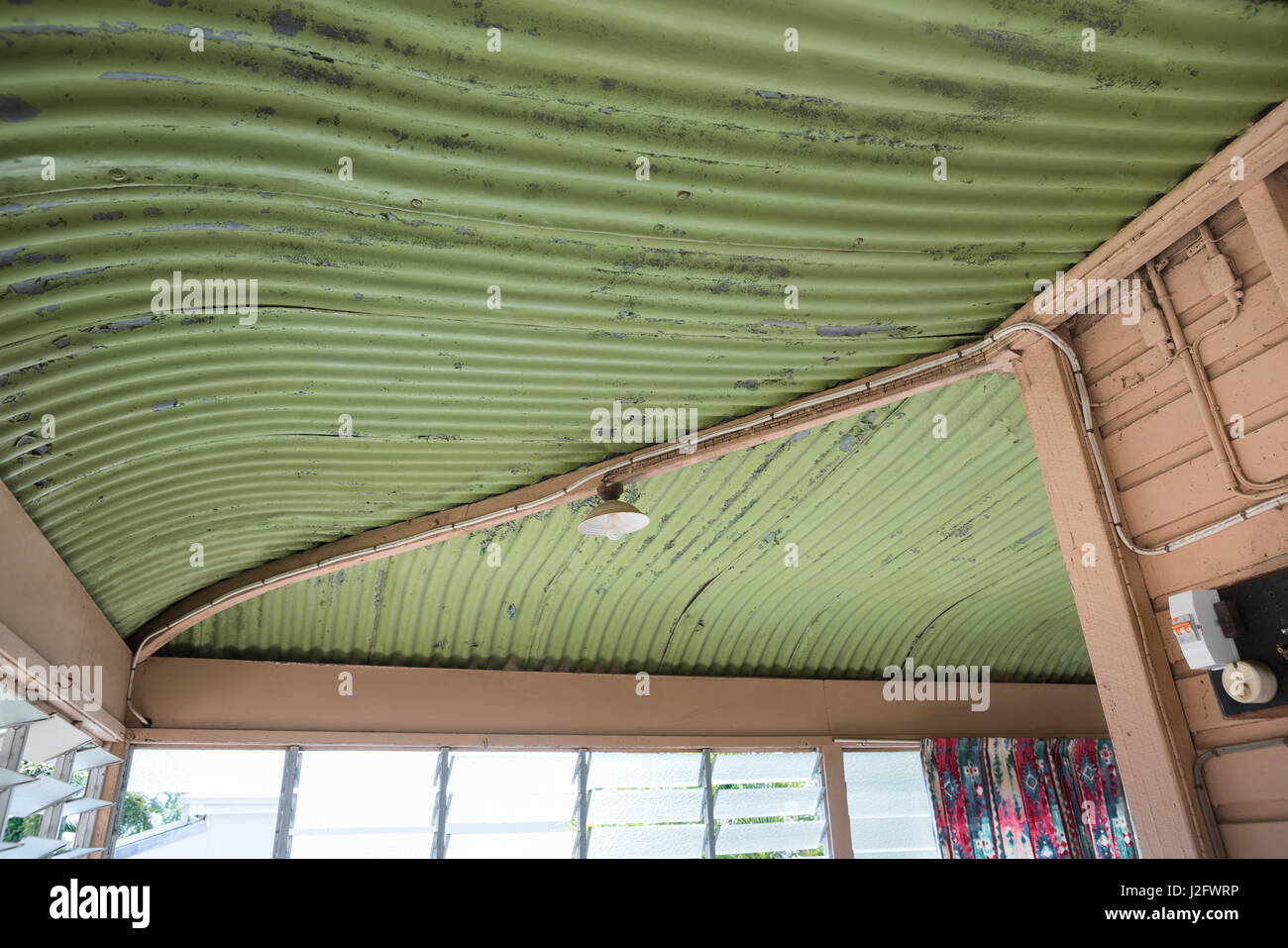Traditional old curved iron roof on a house to be renovated, old ...