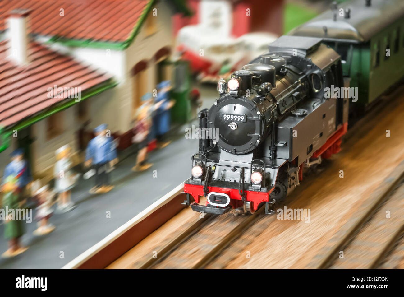 model railroad steam locomotive (with fake number) speeding through a ...