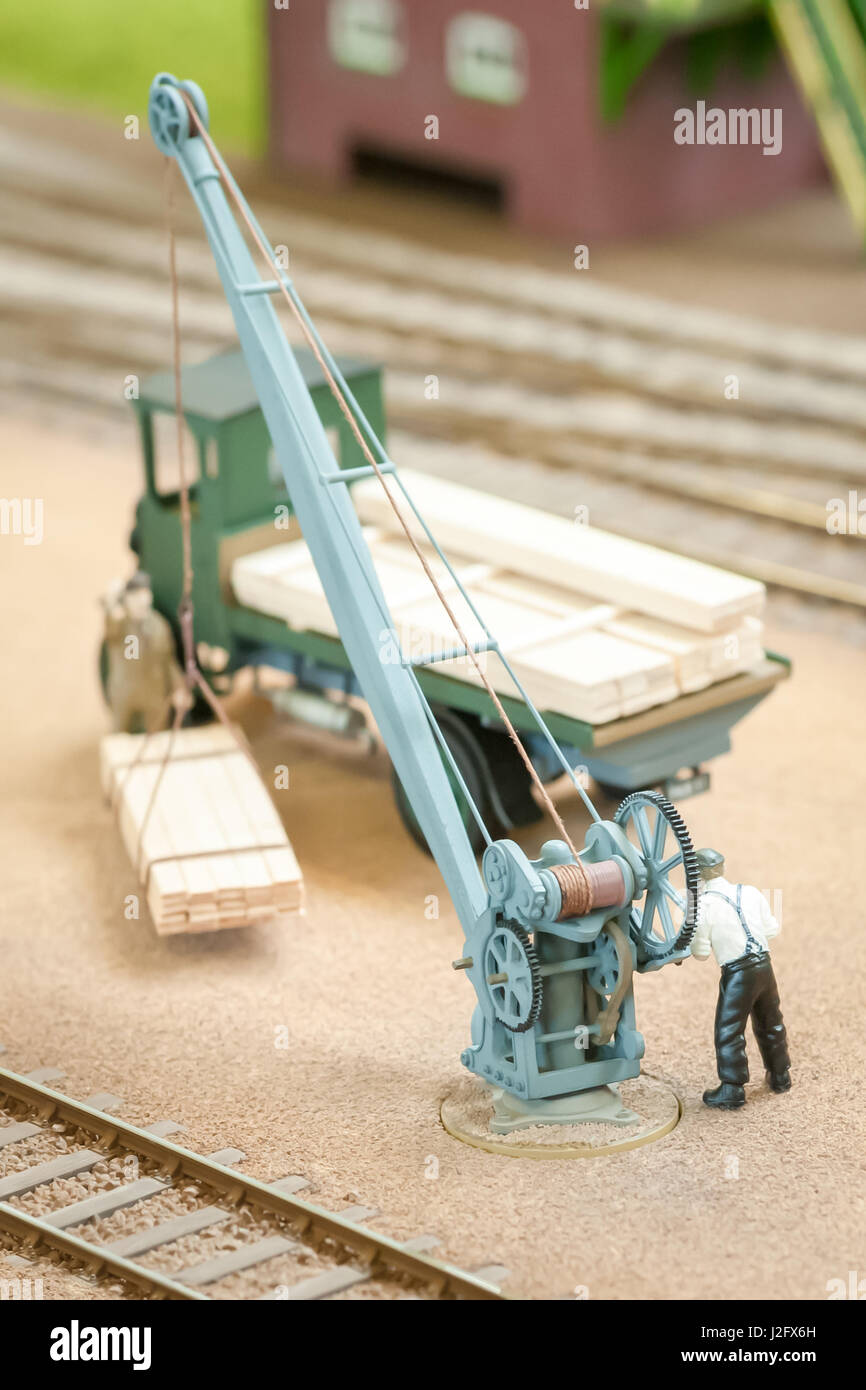 miniature figure loading wood with a hoist Stock Photo - Alamy