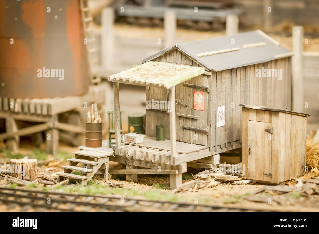 miniature model of a rundown wooden shack beside a railroad - shallow d ...