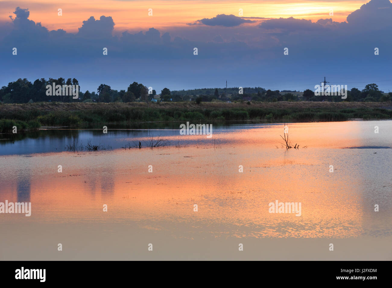 Sunset summer lake landscape with sun reflection on water surface (near ...
