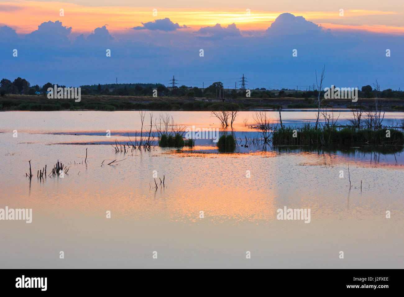Sunset summer lake landscape with sun reflection on water surface (near ...