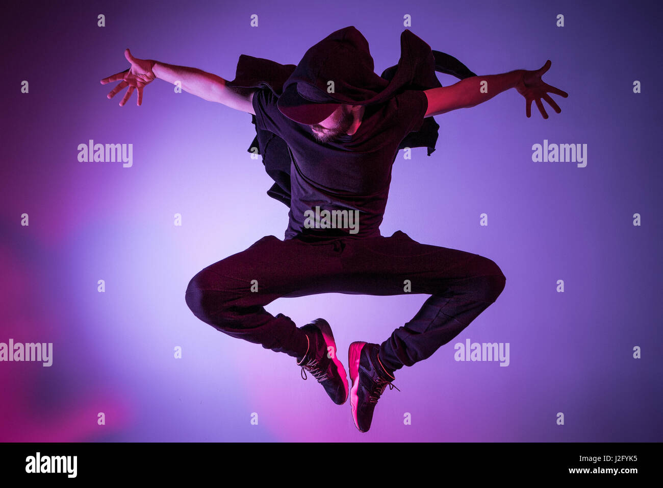 The silhouette of one young hip hop male break dancer dancing on ...