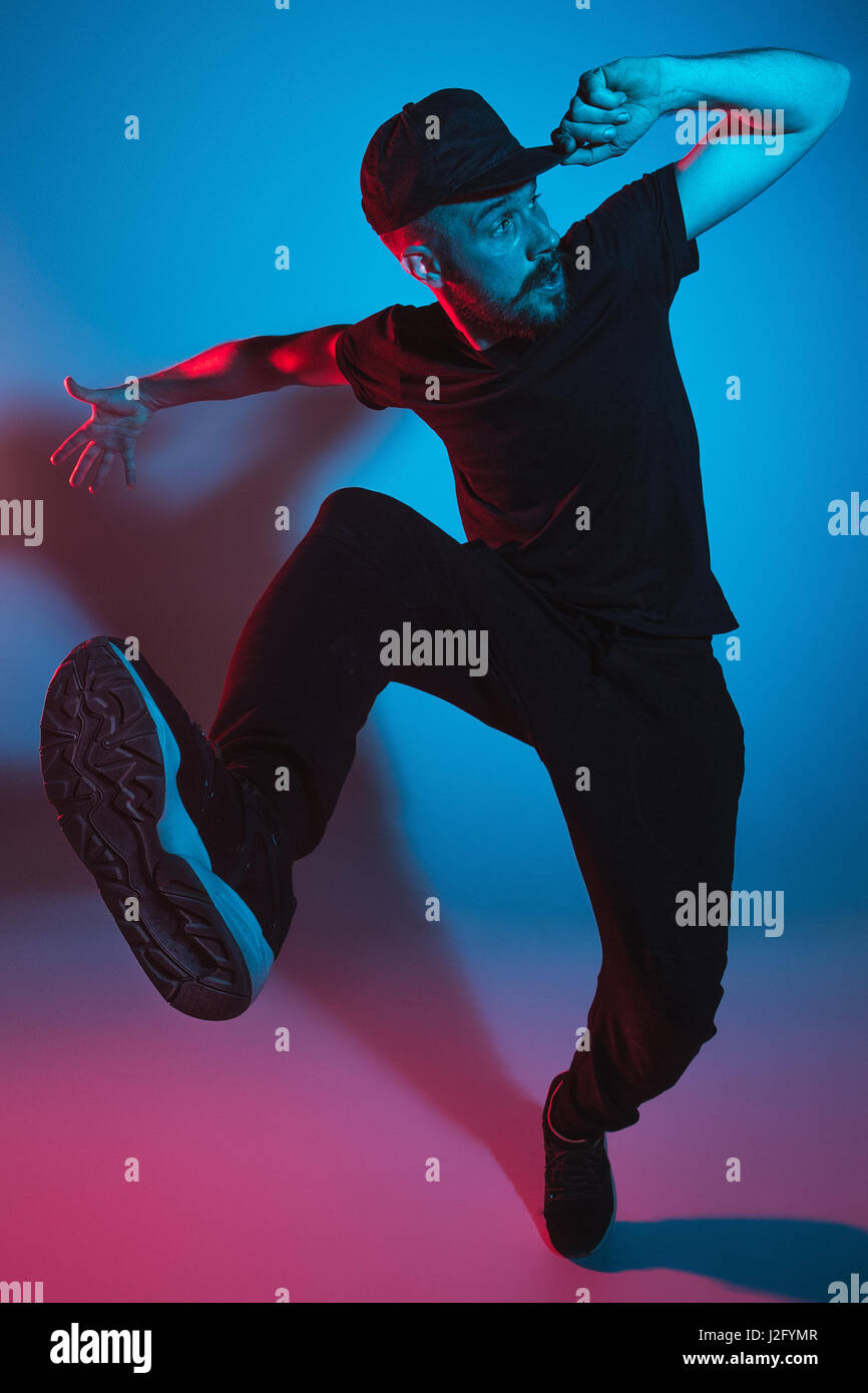 The silhouette of one young hip hop male break dancer dancing on ...