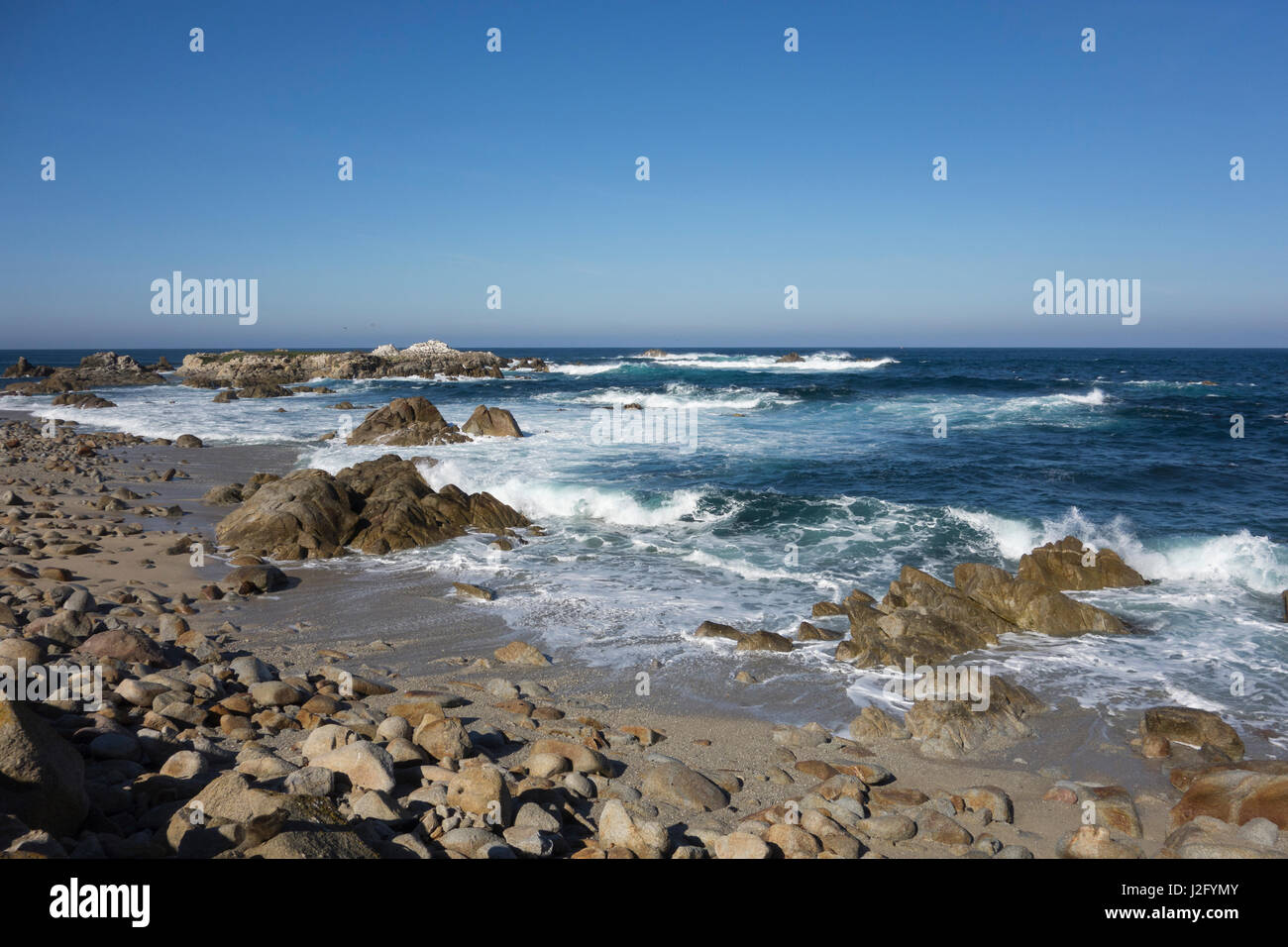 Waves, blue water and rocks along Monterey Peninsula, California coast ...