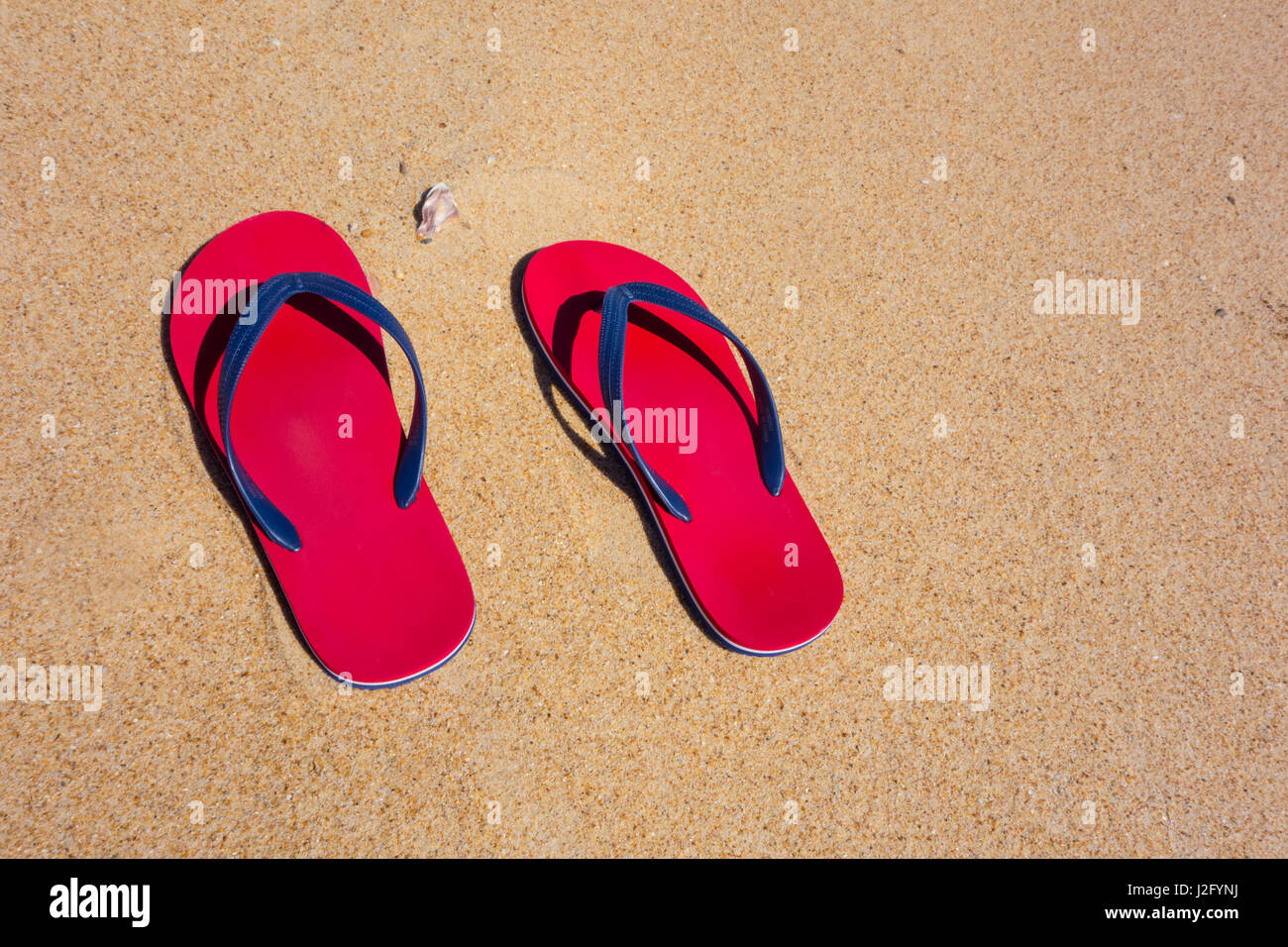 Flip flops on sandy beach Stock Photo - Alamy