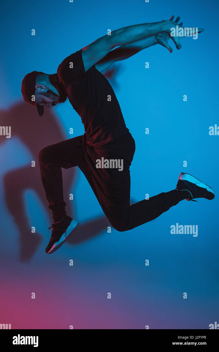 The silhouette of one young hip hop male break dancer dancing on ...