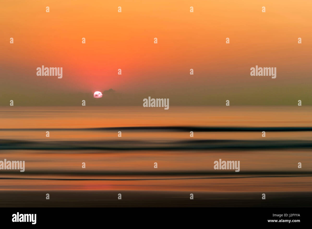 Sunset over rippled water Stock Photo - Alamy