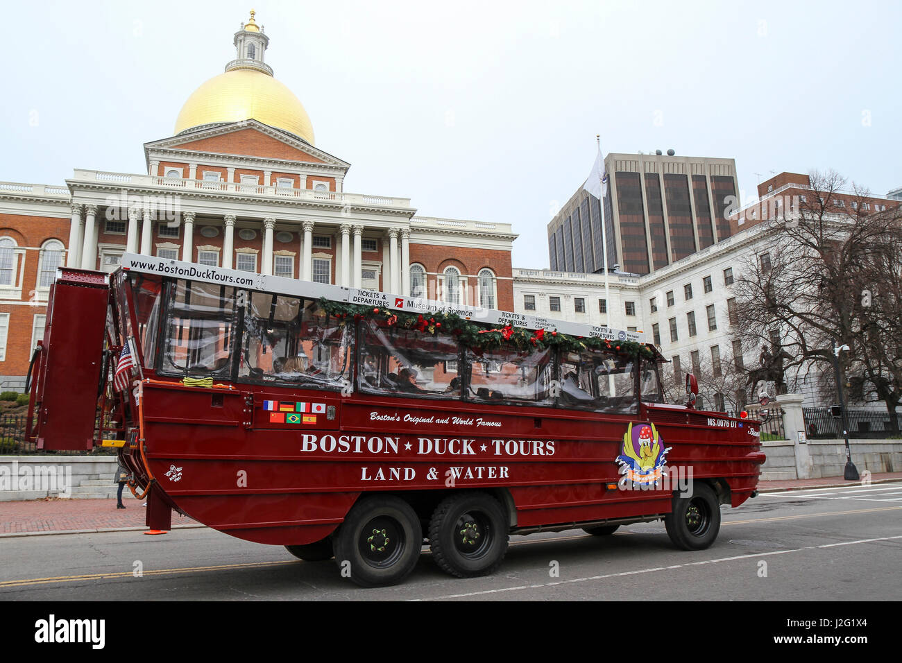 Boston Duck Tours vehicle passes in front of the Massachusetts State ...