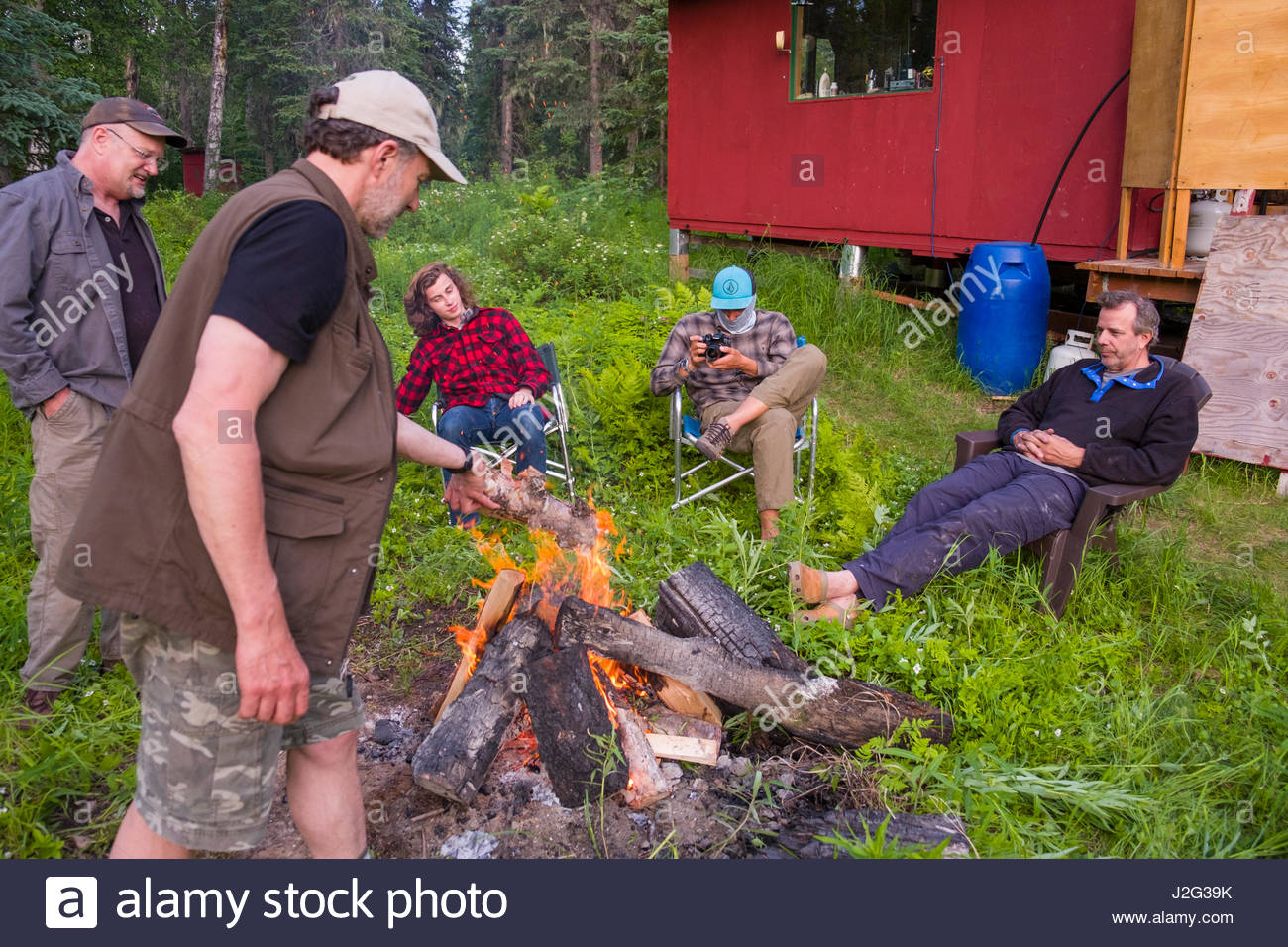 Men Sitting Around Campfire Stock Photos & Men Sitting Around Campfire ...
