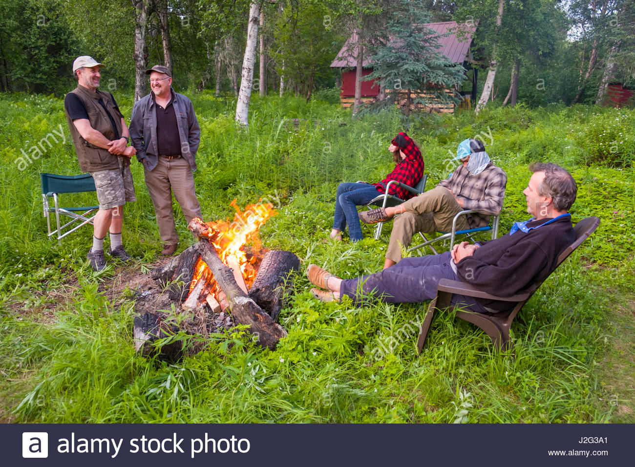 Men Sitting Around Campfire Stock Photos & Men Sitting Around Campfire ...