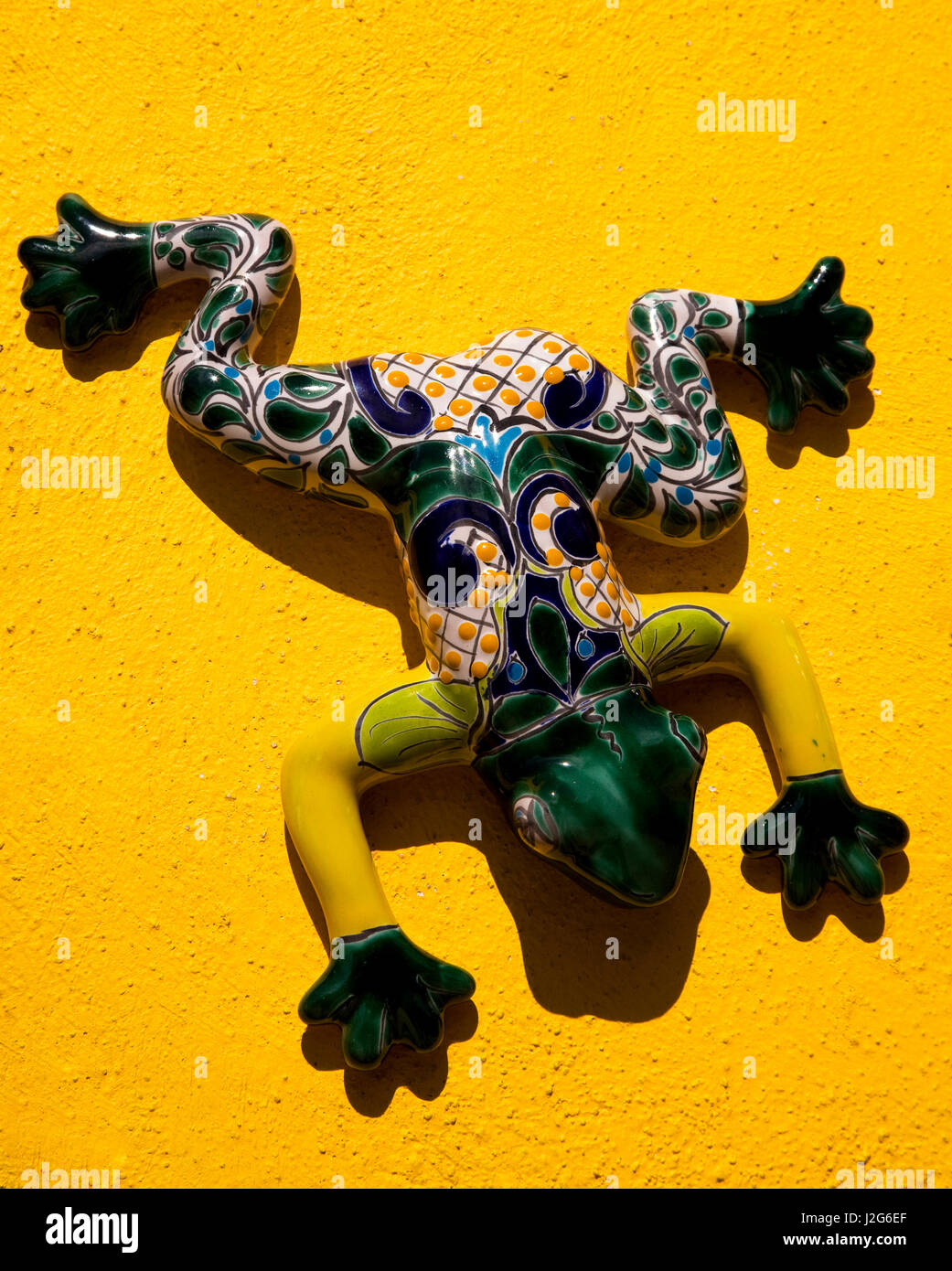 Mexican ceramic frog, yellow wall, Guanajuato, Mexico. Guanajuato is ...