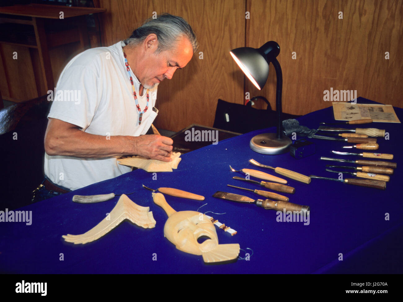 Traditional Athabaskan wood carver demonstrates how he uses a simple ...