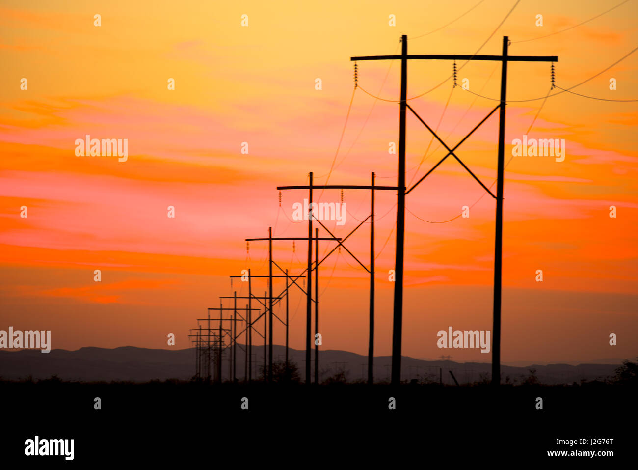 Power lines reach across the desert at sunset. (Large format sizes ...