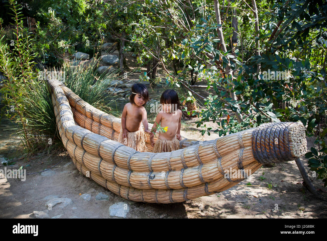 Two California Native children dressed in traditional grass skirts play ...