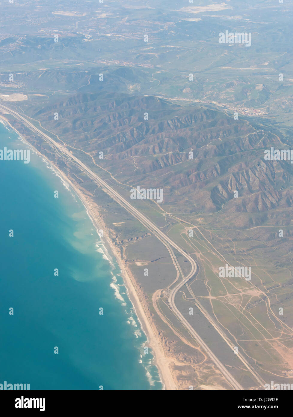 Usa, California. Aerial of undeveloped coastline Camp Pendleton. Cars ...