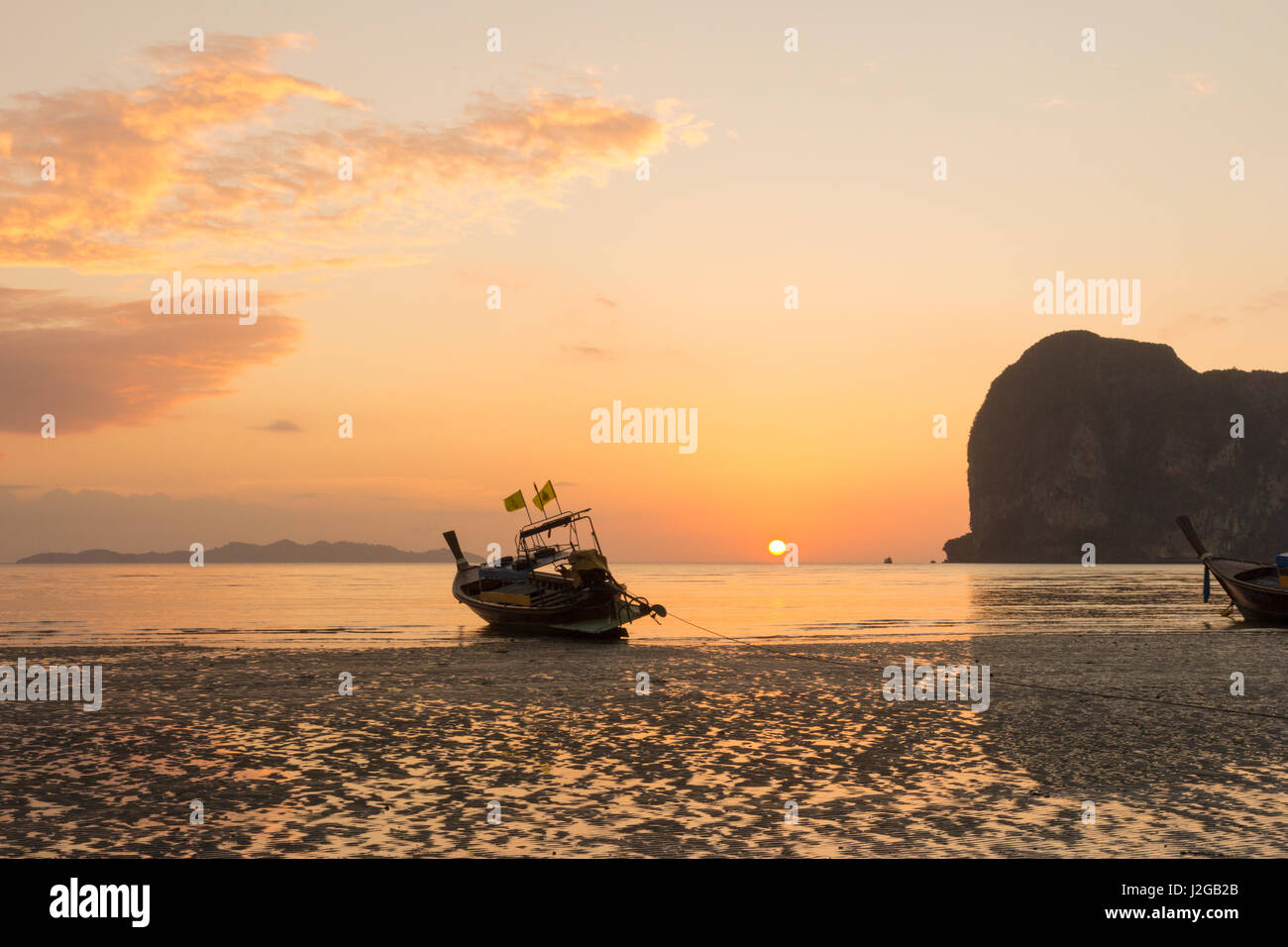 Long tail boat on Pak Meng beach, Trang province, Thailand at sunset ...