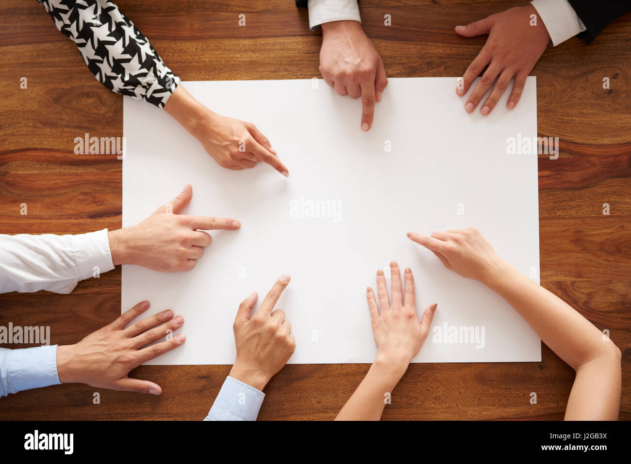 Human hands pointing at empty white card Stock Photo - Alamy