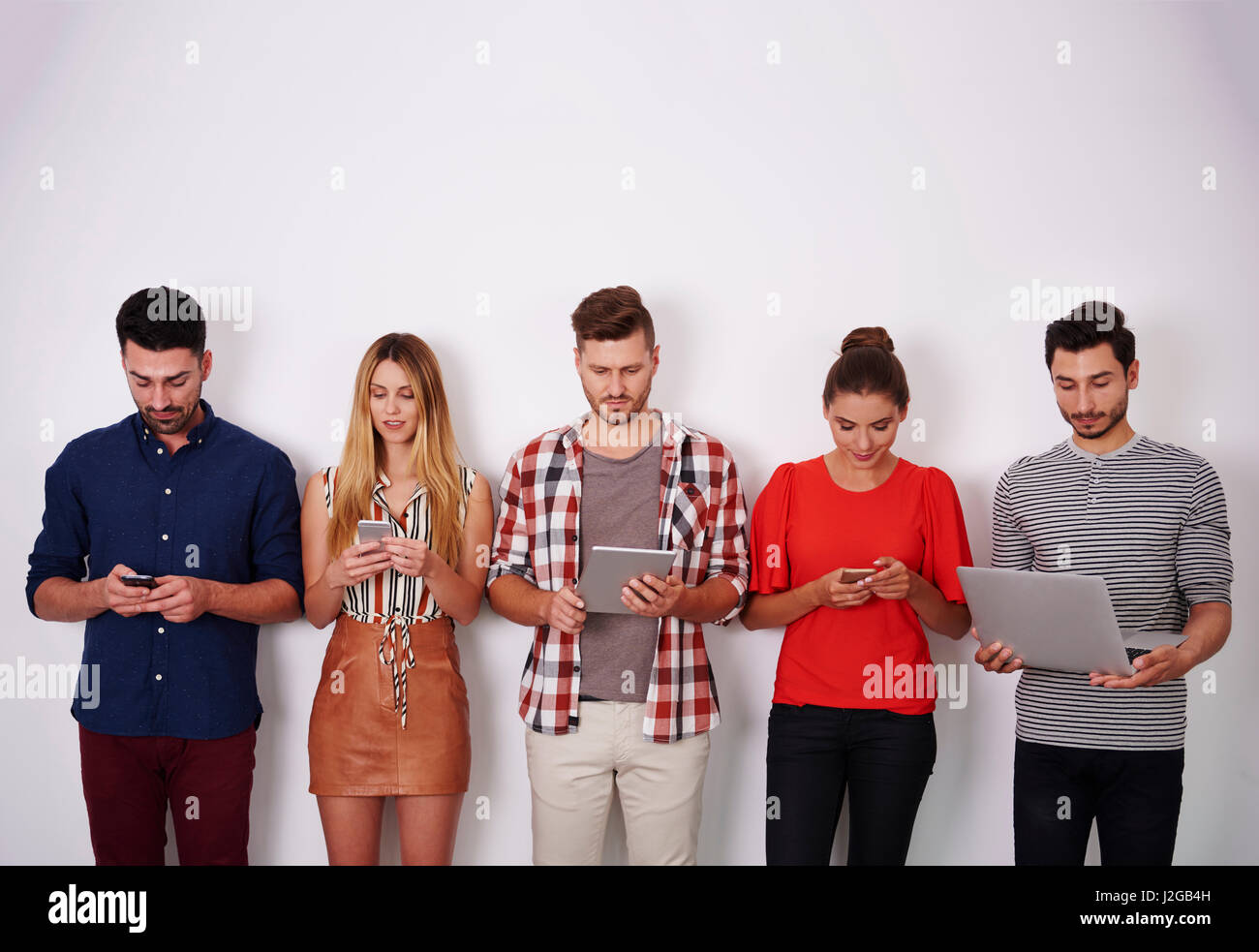 Group of people holding in hand a mobile devices Stock Photo - Alamy