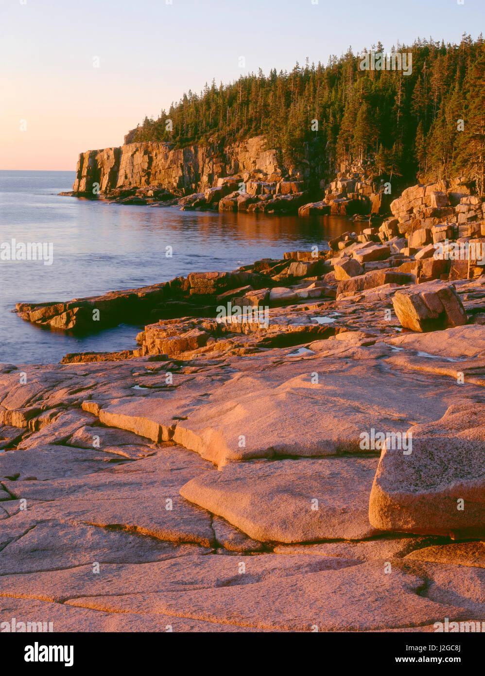 USA, Maine, Acadia National Park, Sunrise light on rocky, granite ...