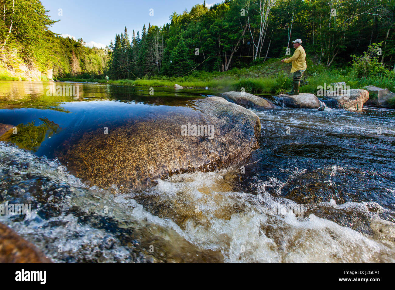 A man fly-fishing for brook trout in Cold Stream in Maine's Northern ...